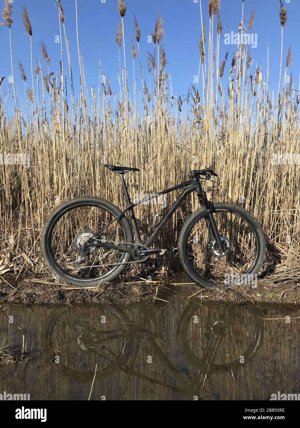 Mountain bike with reflection in the water Stock Photo - Alamy