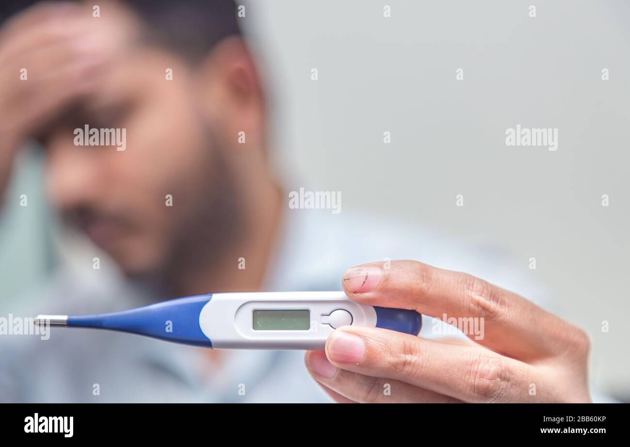Novel corona virus COVID-19 -Sad man with tensed face holding digital ...