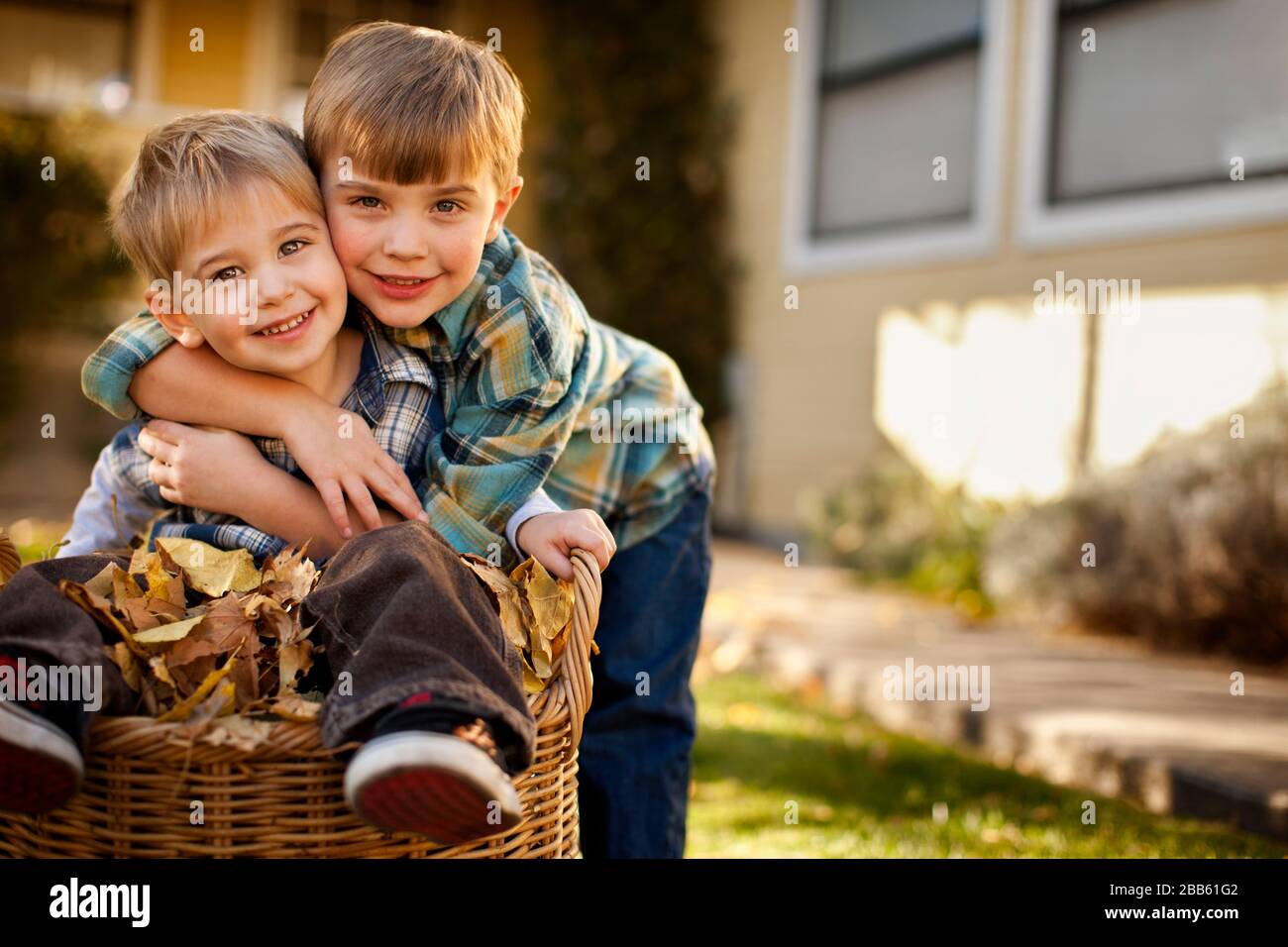Two young brothers at play embracing on a crisp fall day Stock Photo ...