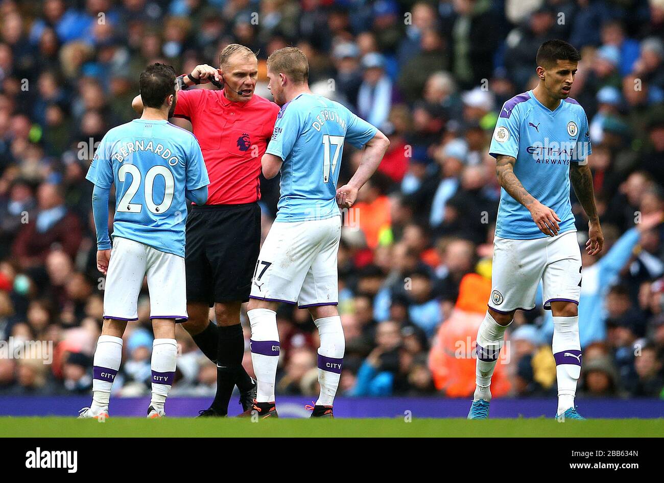 Match referee Graham Scott (left) and Manchester City's Kevin De Bruyne ...