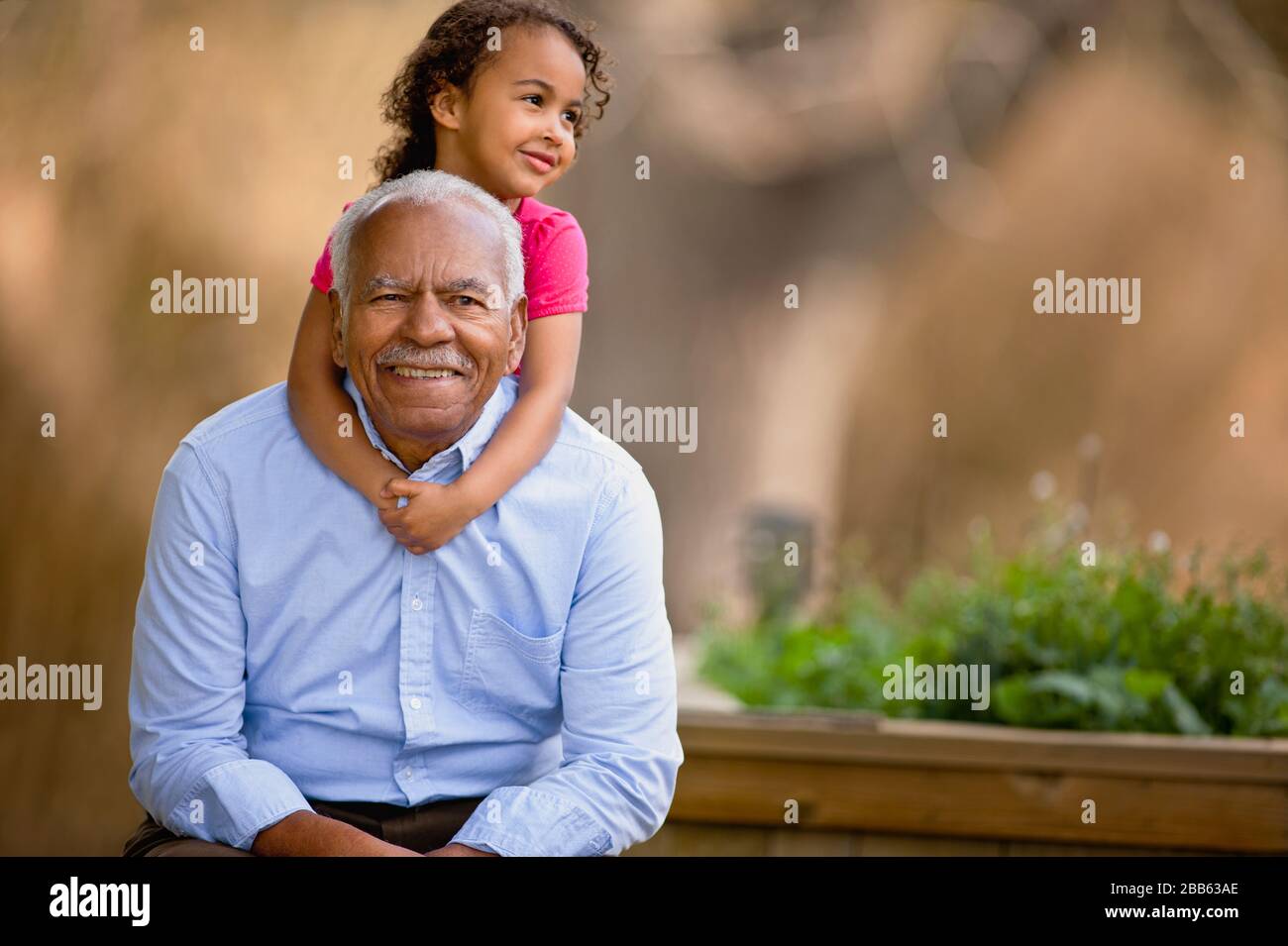 Little girl hugging her smiling grandfather Stock Photo - Alamy