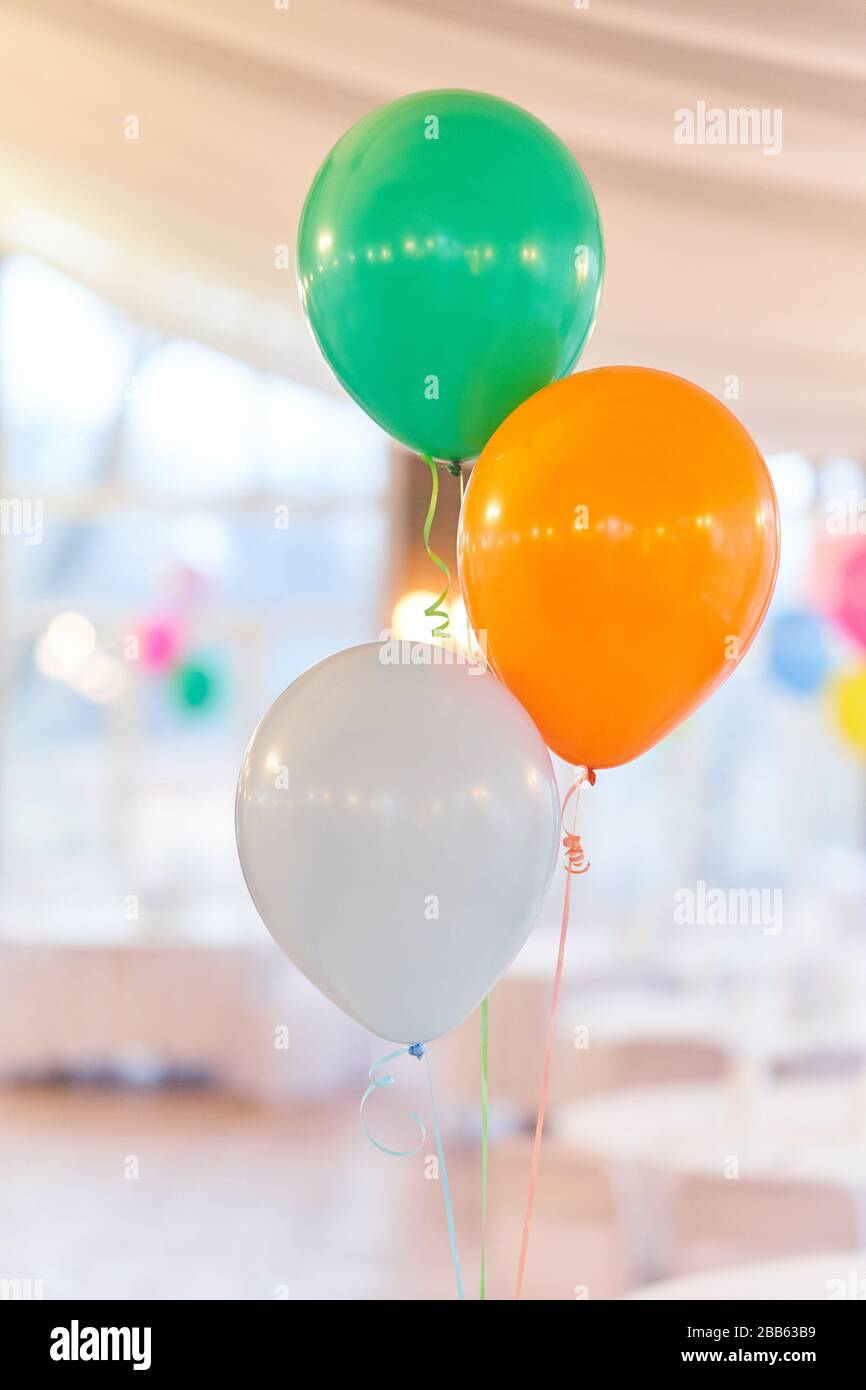 Three multi-colored balloons on holiday. Close-up balloons at an event ...
