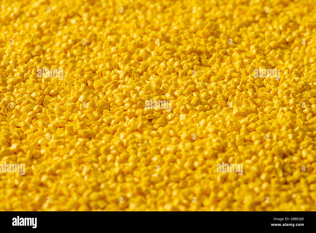 Granular recycled yellow plastic Stock Photo - Alamy