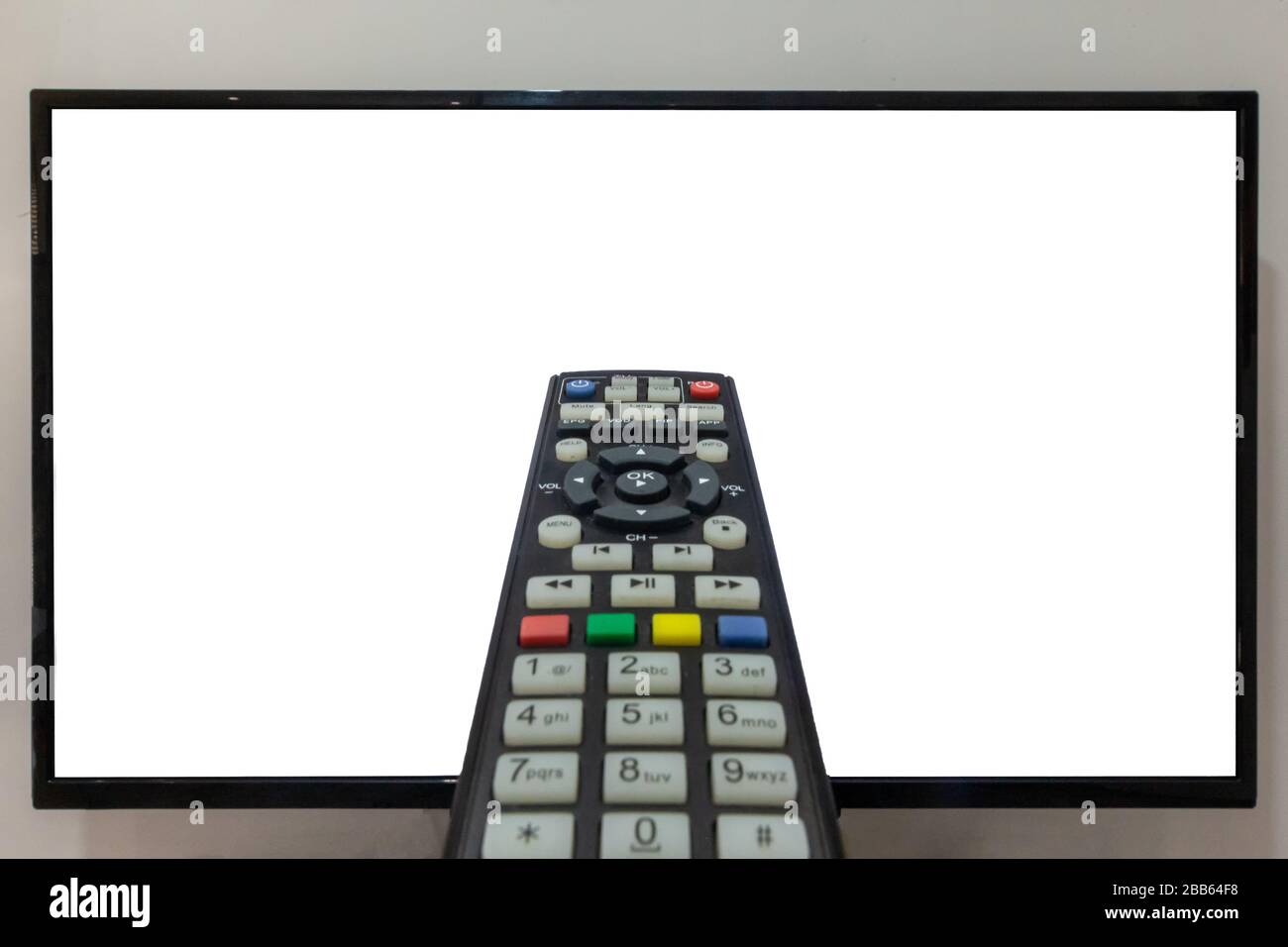 Person poining a TV remote and pressing the power button isolated on ...