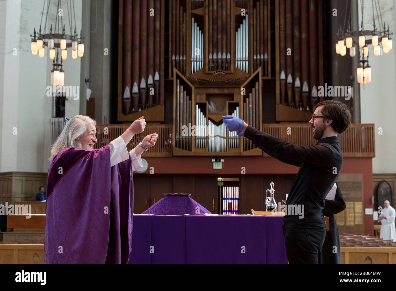 The Reverend Jennifer King Daugherty (l) prepares for a livestream-only ...