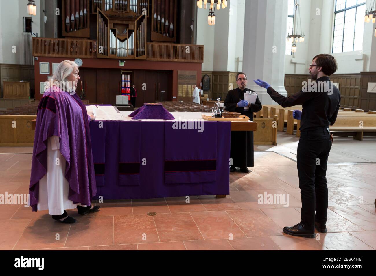 Altar guild Morgan Randall (r) prepares for a livestream-only service ...