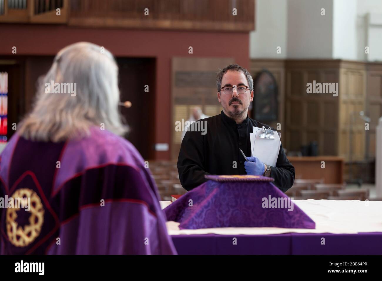 The Reverend Jennifer King Daugherty (l) prepares for a livestream-only ...