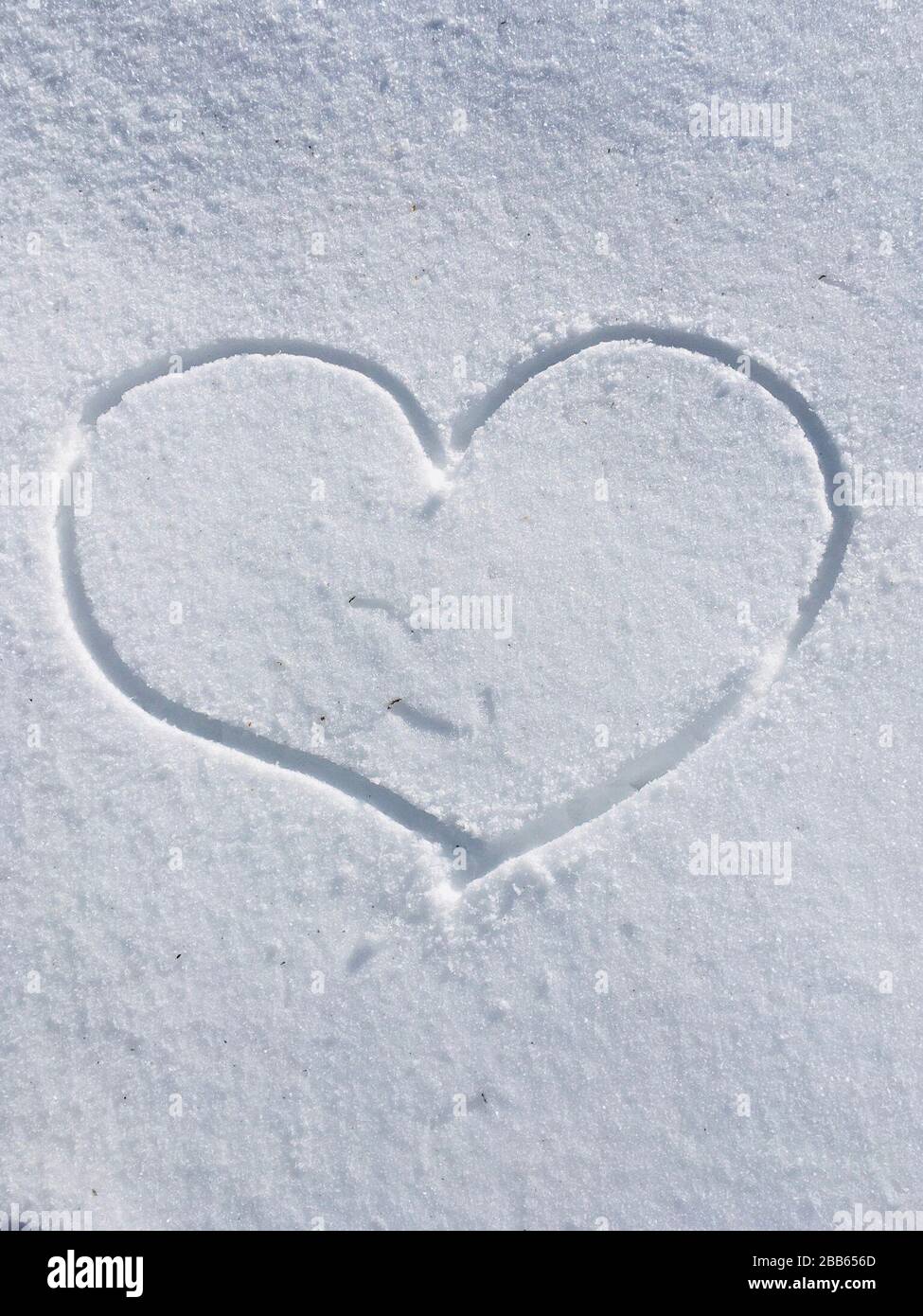 Heart shape in the snow Stock Photo - Alamy