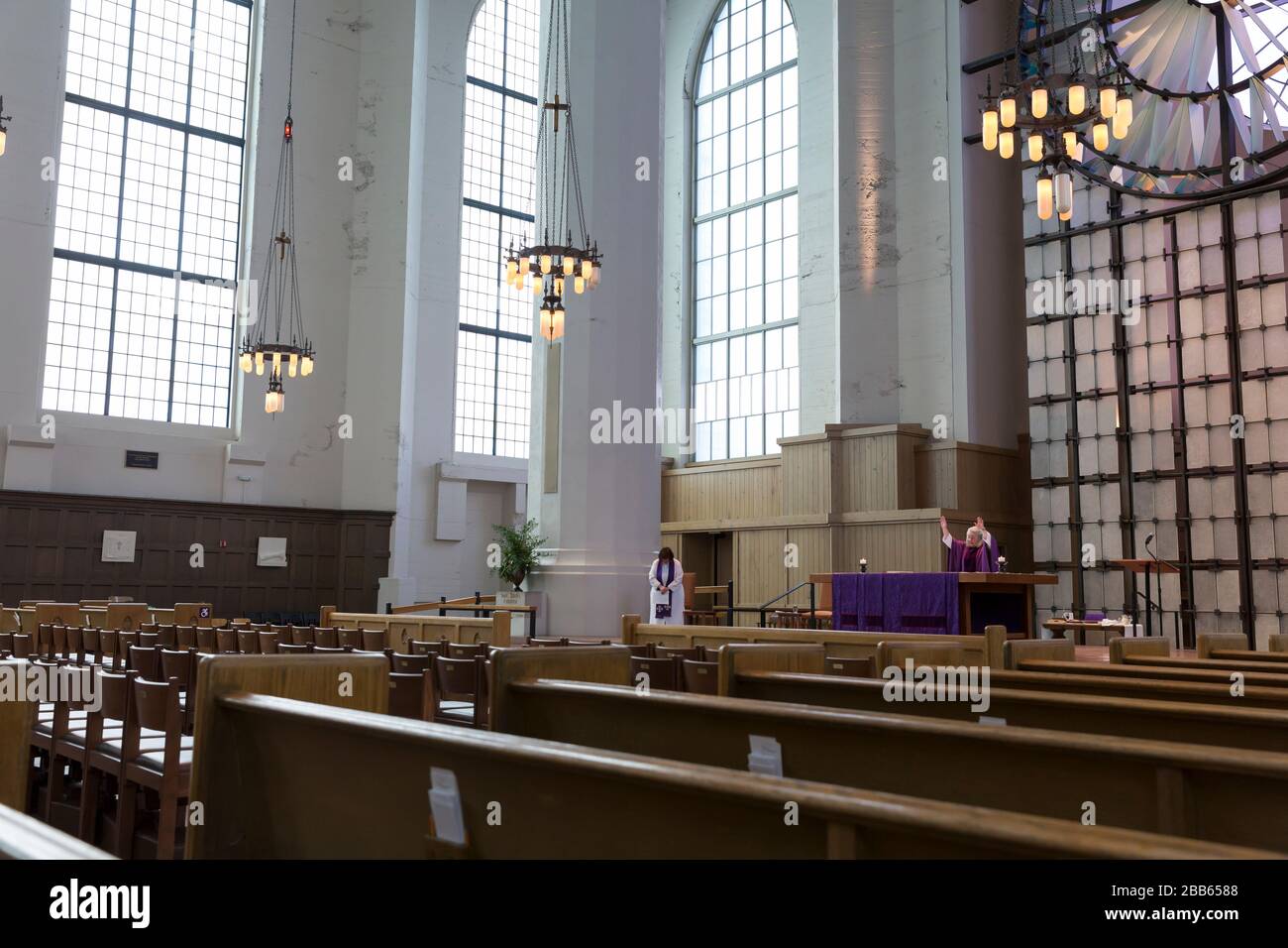 The Reverend Jennifer King Daugherty (r) recites a prayer with the ...