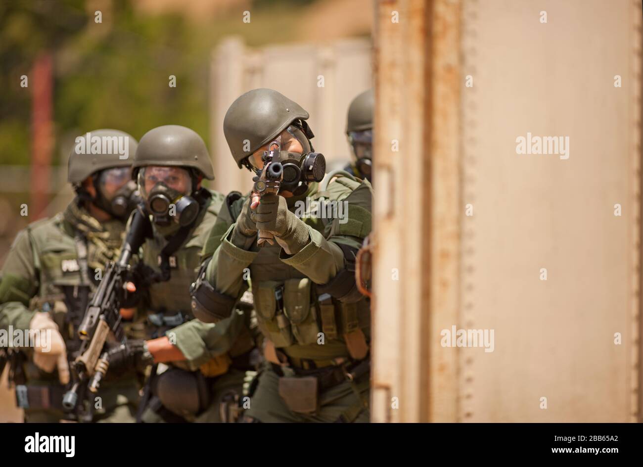 Group of police officers about to enter a building during an exercise ...