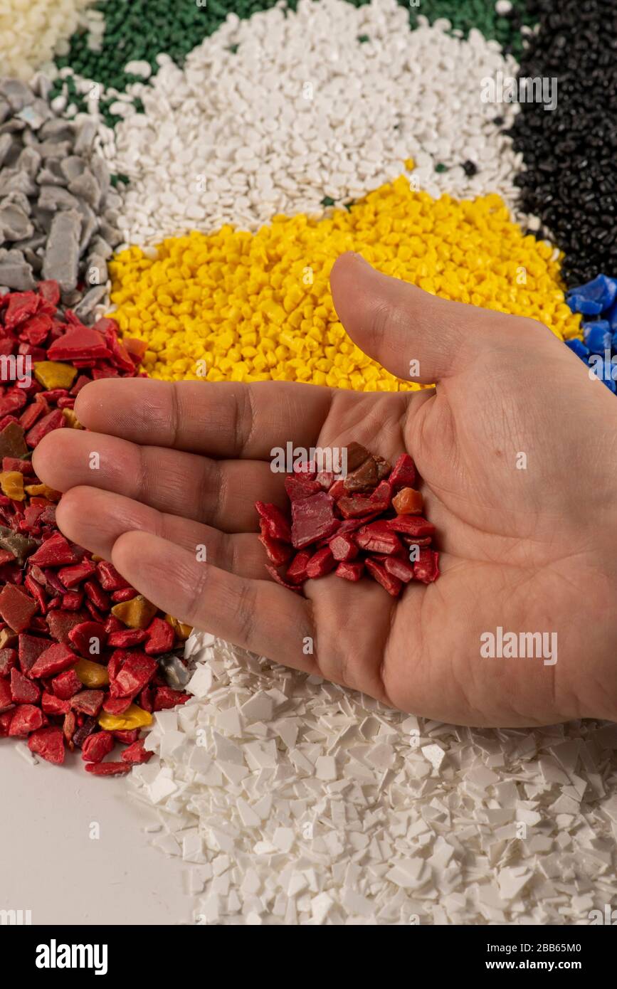 Granular recycled plastic in hand Stock Photo - Alamy