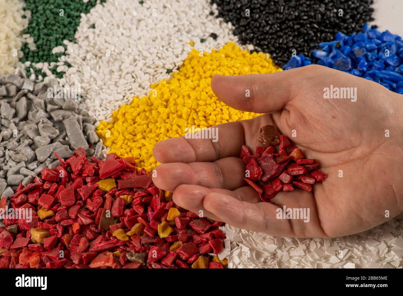 Granular recycled plastic in hand Stock Photo - Alamy
