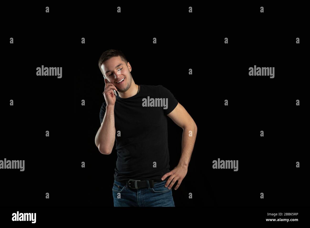 Talking on phone. Monochrome portrait of young caucasian man isolated ...