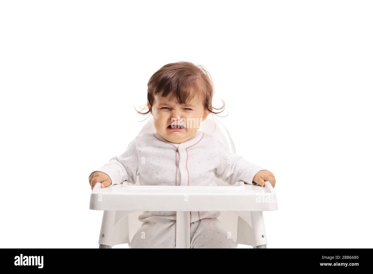 Baby sitting in a baby chair and crying isolated on white background ...