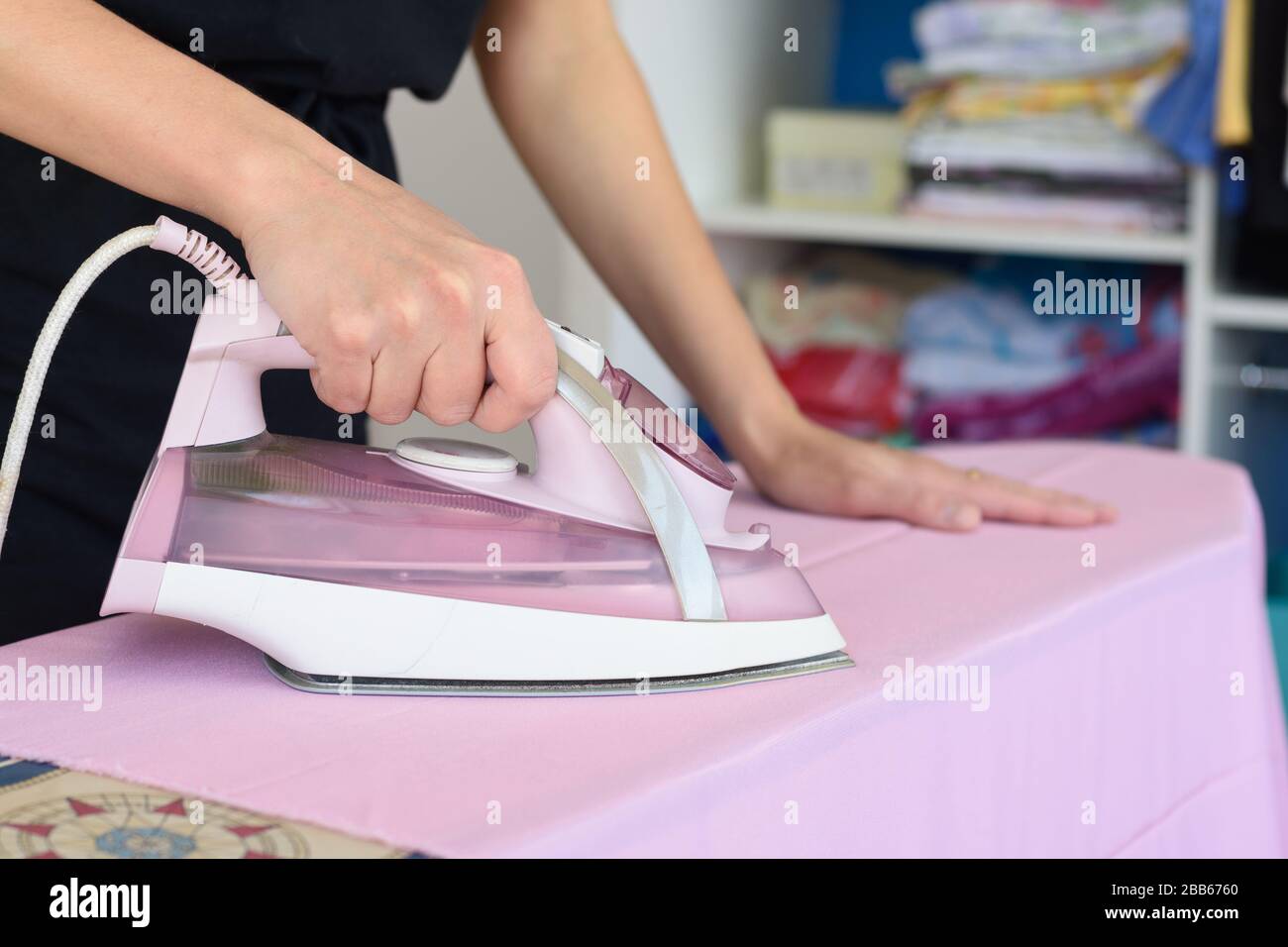 Girl ironing cloth on an ironing board, close-up Stock Photo - Alamy