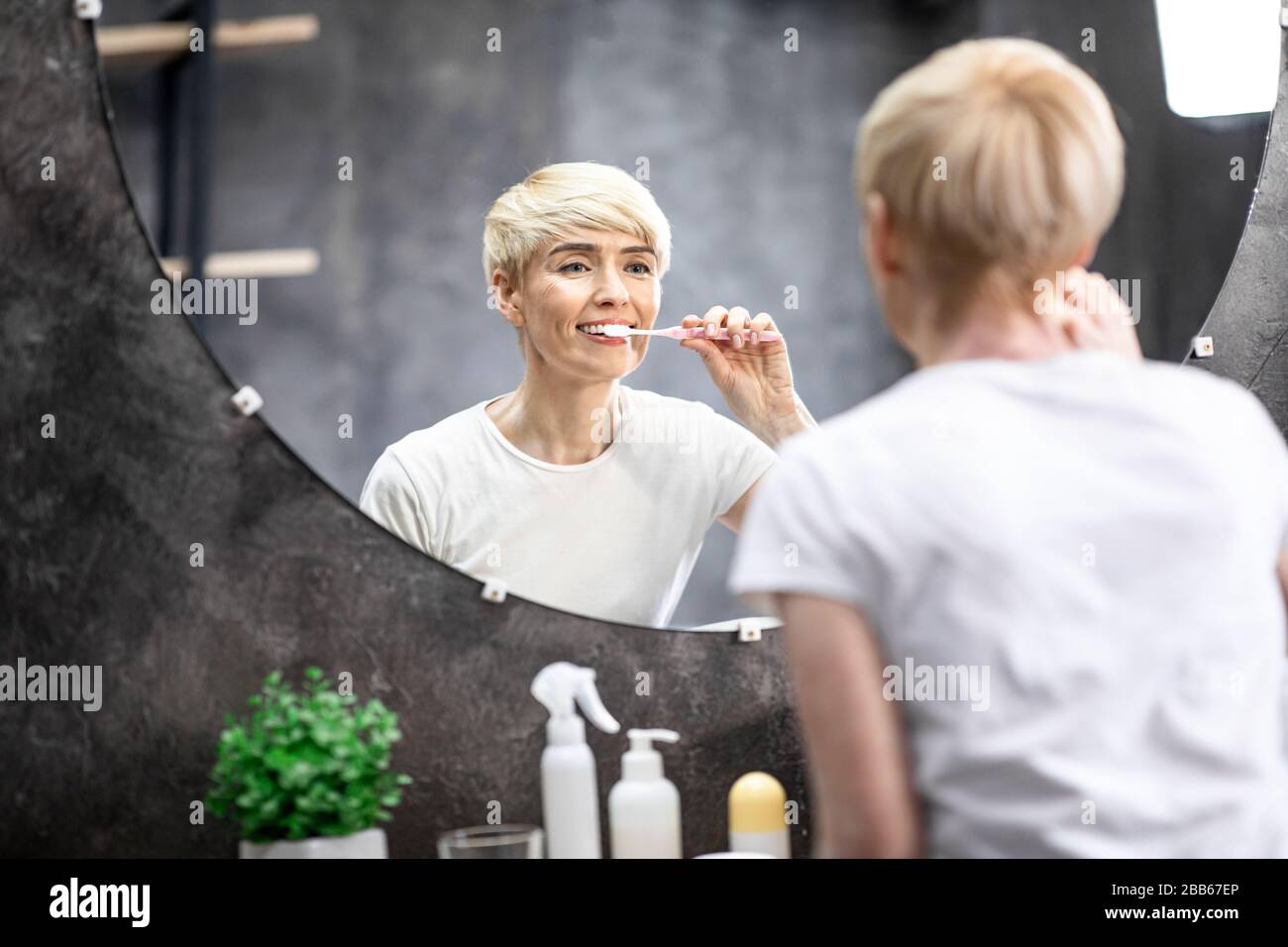 Mature Lady Brushing And Cleaning Teeth In Bathroom At Home Stock Photo ...
