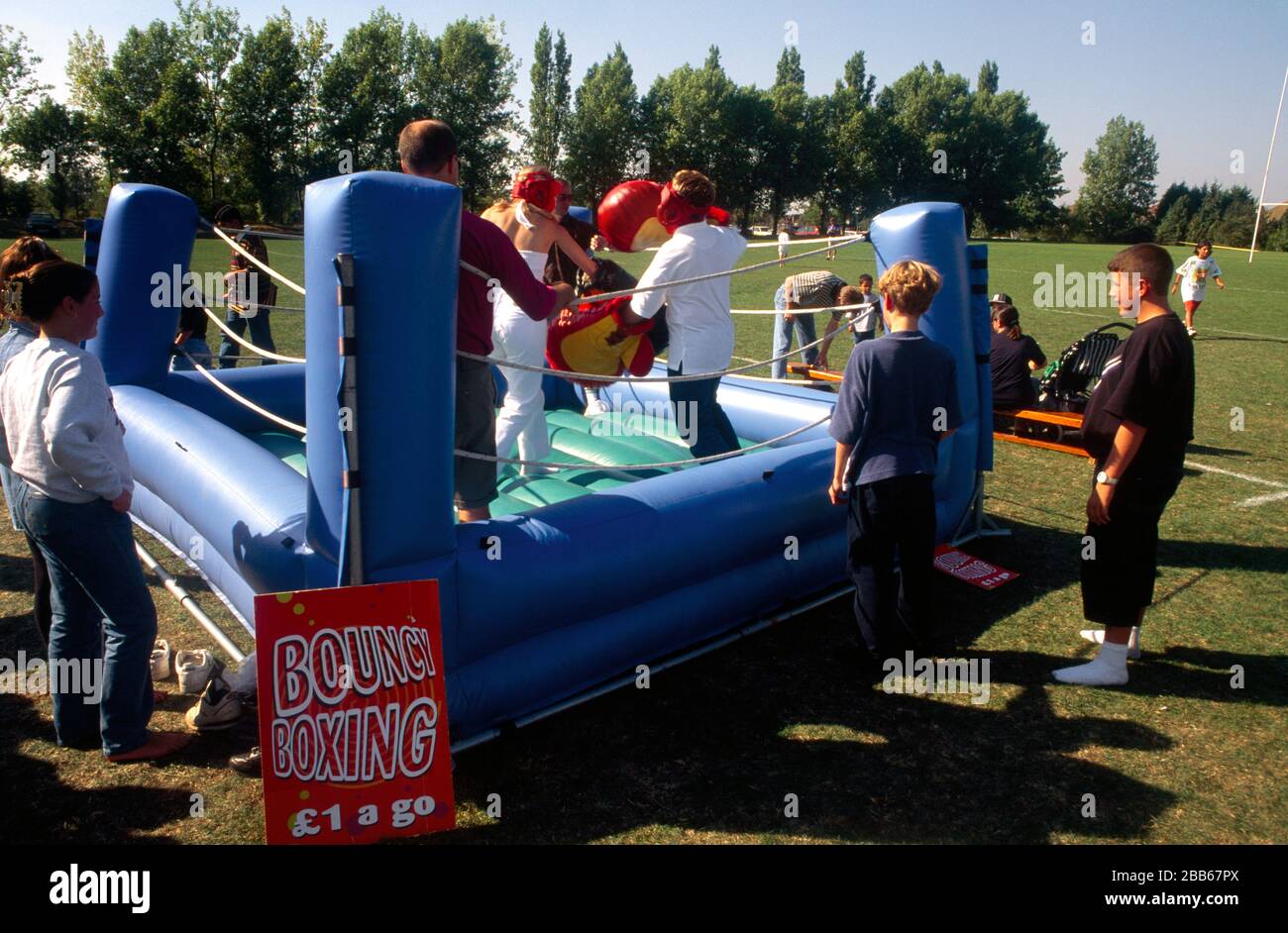 School Fete In Local Park Children Playing Bouncy Boxing England Stock ...