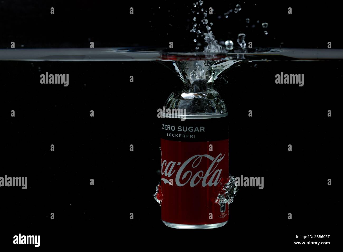 Close up view of can falling in water. Coca cola Stock Photo - Alamy