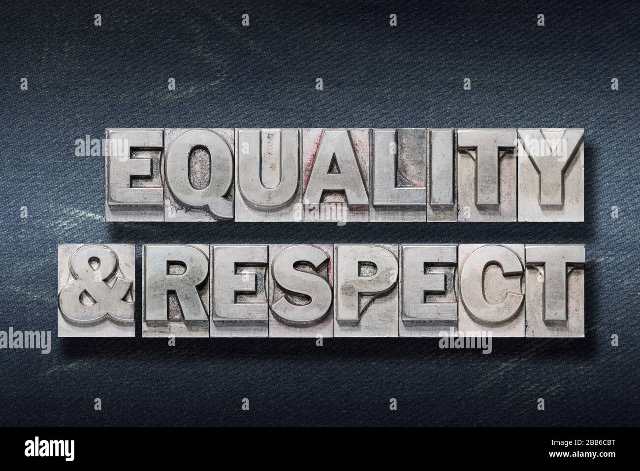 equality and respect words made from metallic letterpress on dark jeans ...