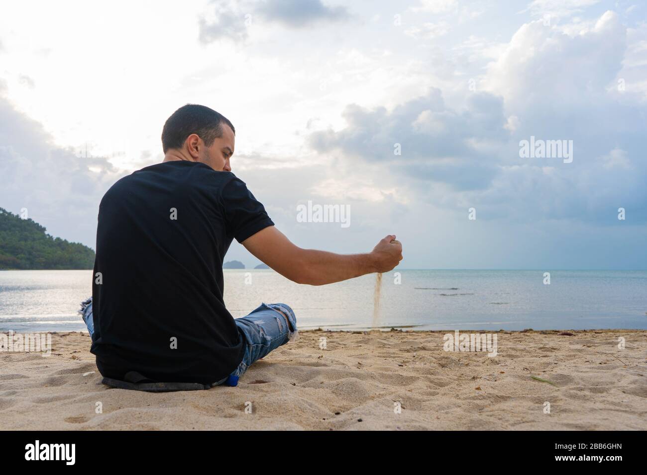 Man sits on beach plays hi-res stock photography and images - Alamy