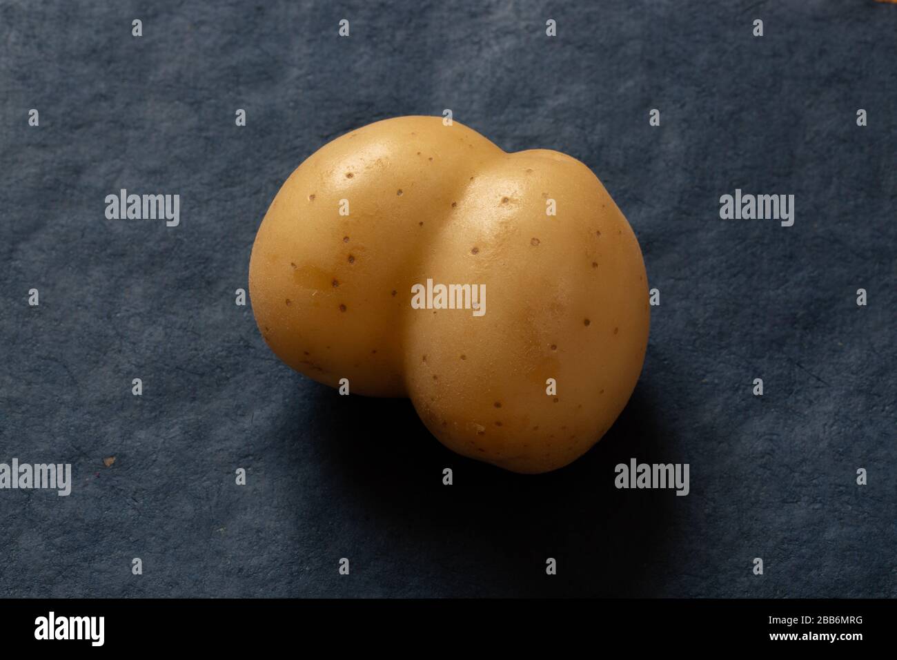 Buttocks shaped potato Stock Photo - Alamy
