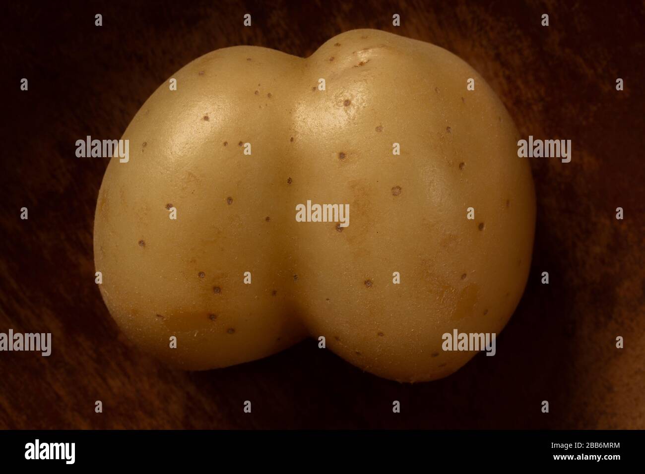 Buttocks shaped potato Stock Photo - Alamy