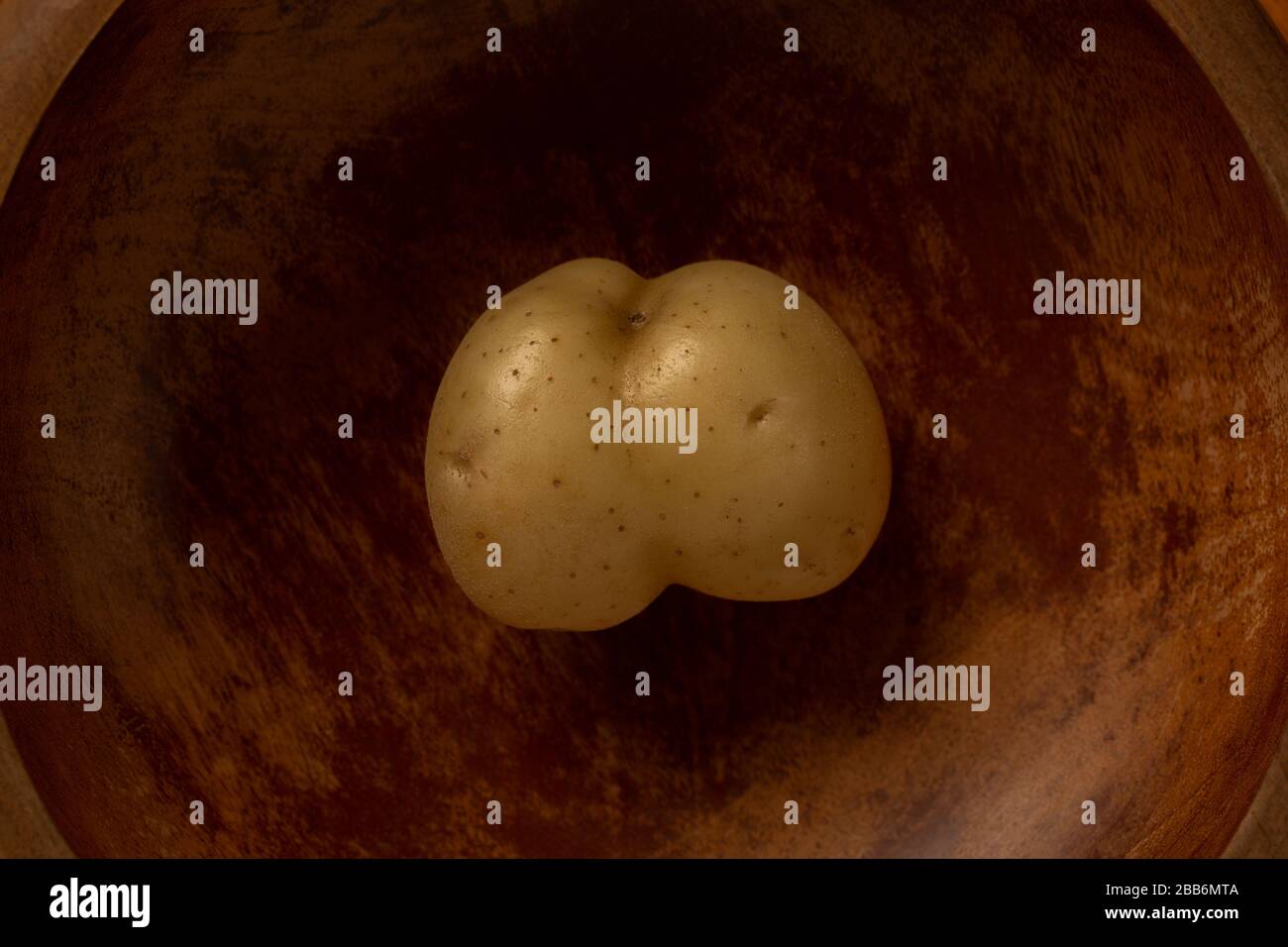 Buttocks shaped potato Stock Photo - Alamy