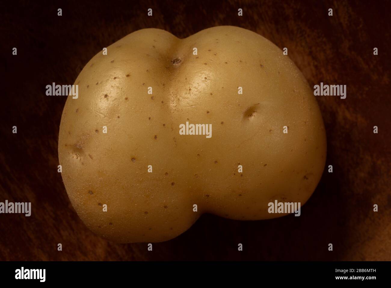 Buttocks shaped potato Stock Photo - Alamy
