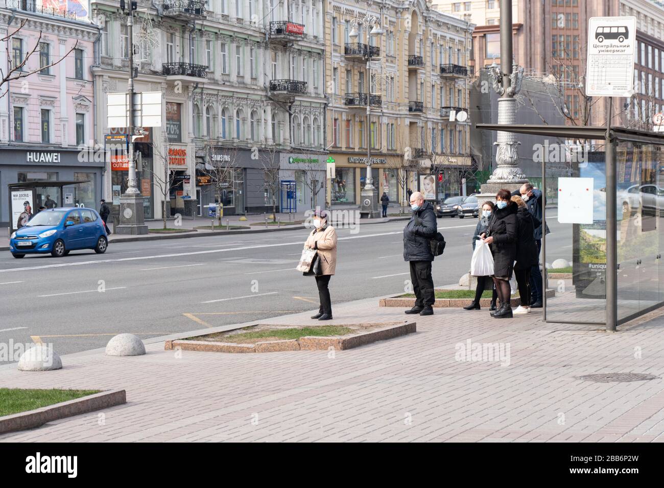 Kiev, Ukraine, March 27, 2020, people with facial masks waiting bus at ...
