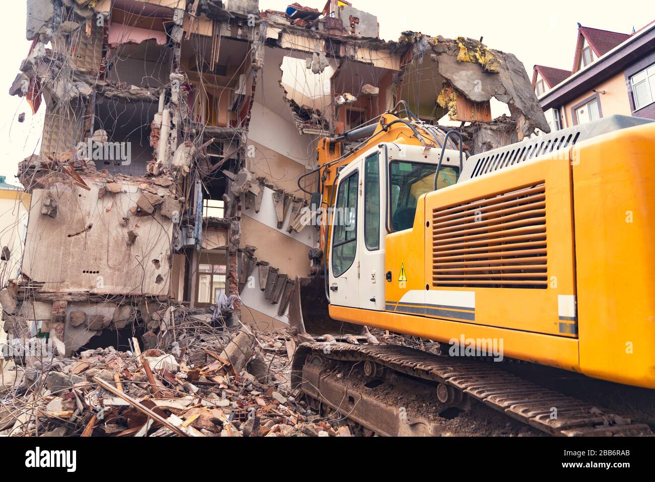 Bulldozer demolishes old buildings. demolition of a building in the ...