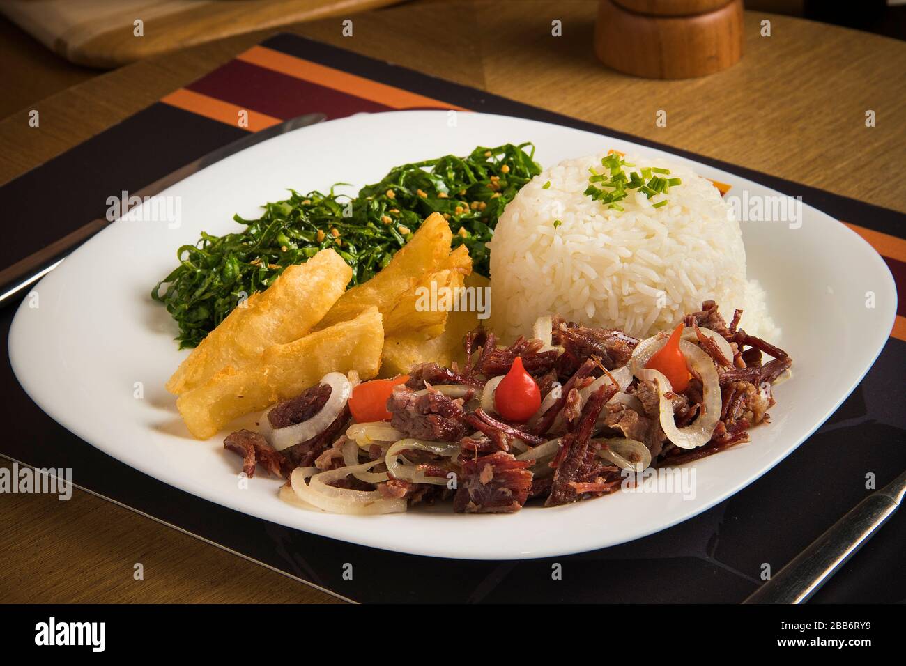 Jerk beef with rice, kale and fried manioc Stock Photo - Alamy