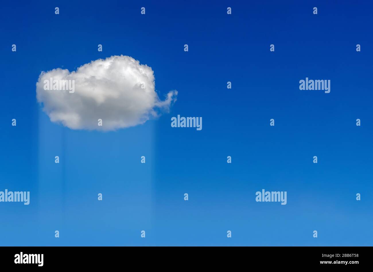 cloud with a stream of rain against the blue sky. small rain cloud ...