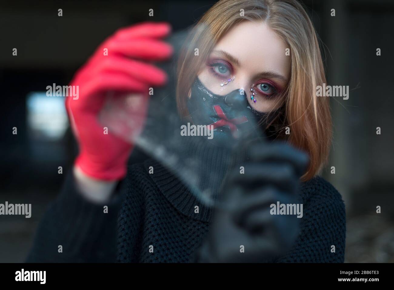 Closeup beauty portrait of a beautiful girl in a black mask with ...