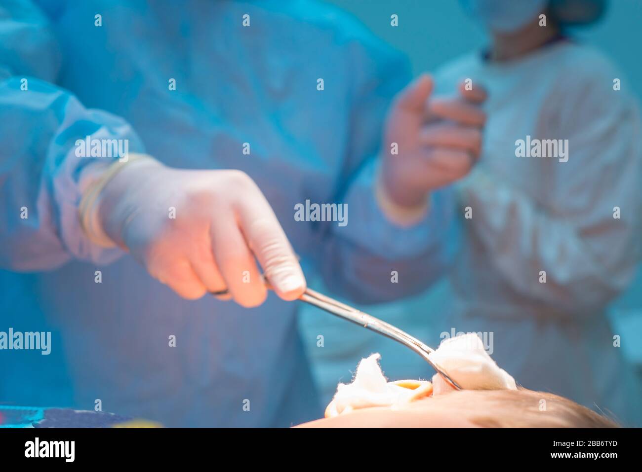 closeup in focus of the hands of pediatric surgeons in gloves, perform ...