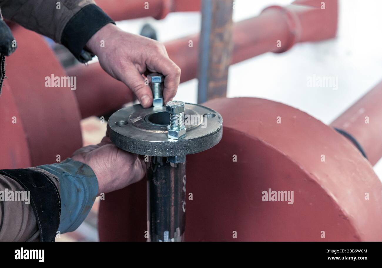 Fitter assembler is assembling a new gas pipeline line in a gas boiler ...