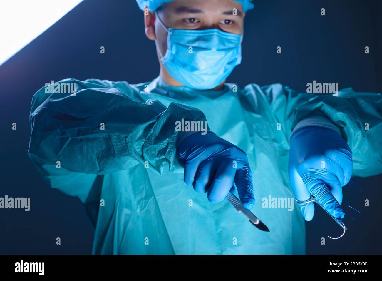 Operating female surgeon guiding hi-res stock photography and images ...