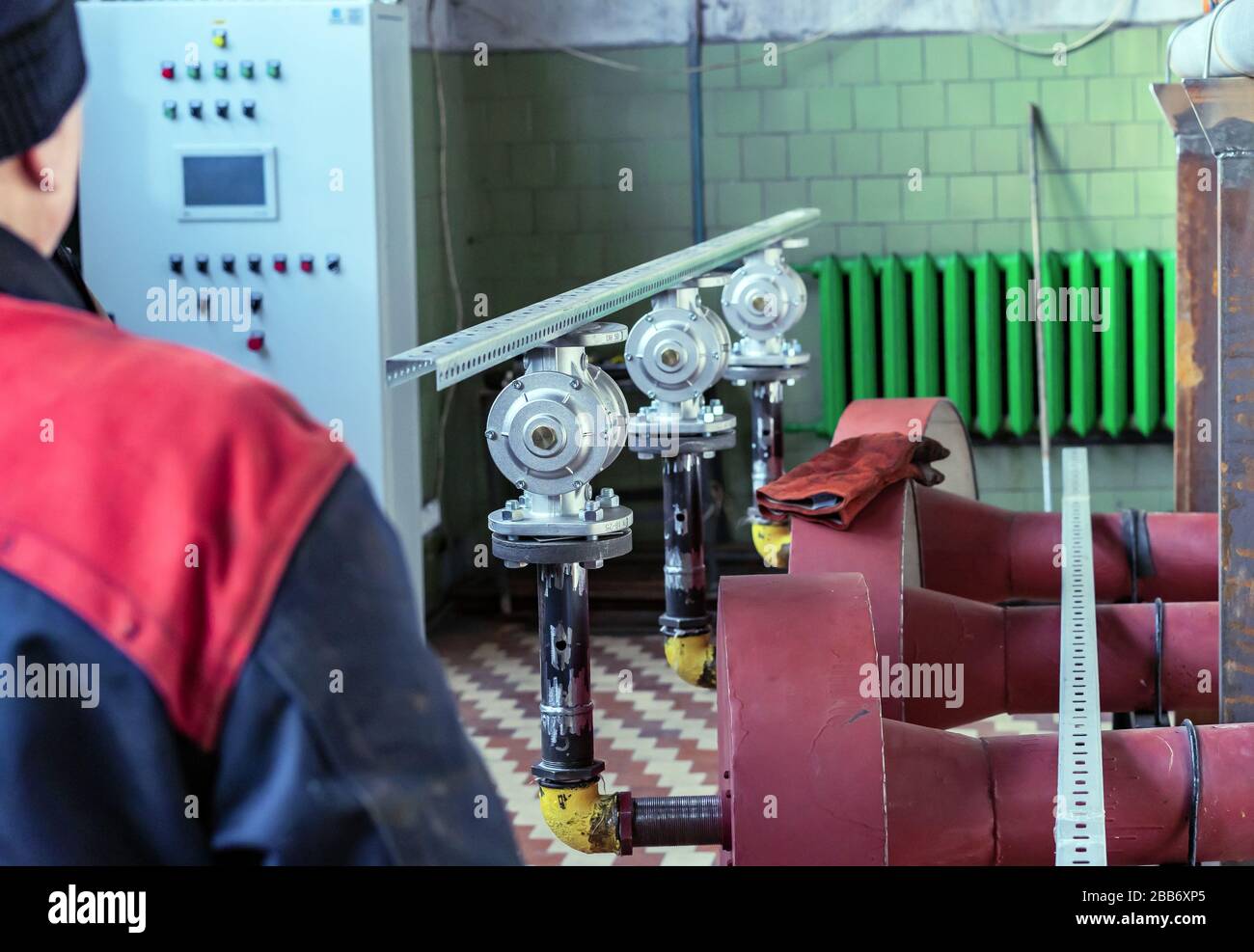 Fitter assembler is assembling a new gas pipeline line in a gas boiler ...