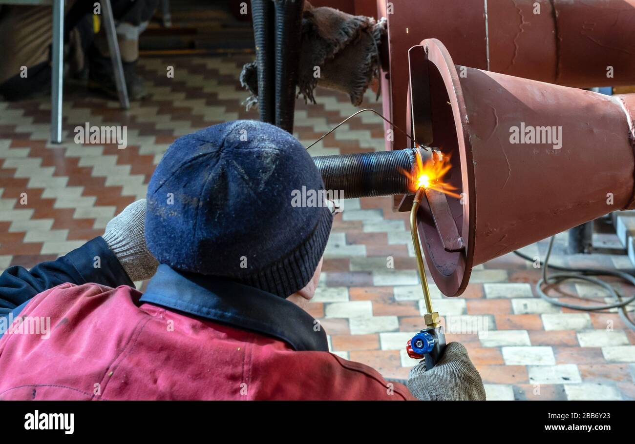 Welder is welding metal structures on a new gas pipeline Stock Photo ...