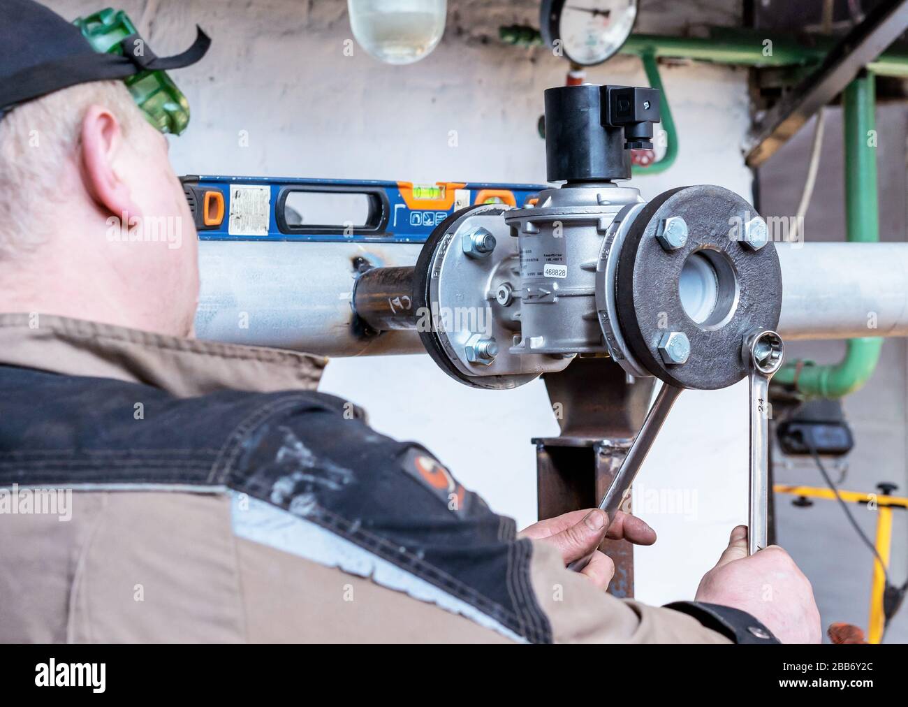 Fitter assembler is assembling a new gas pipeline line in a gas boiler ...