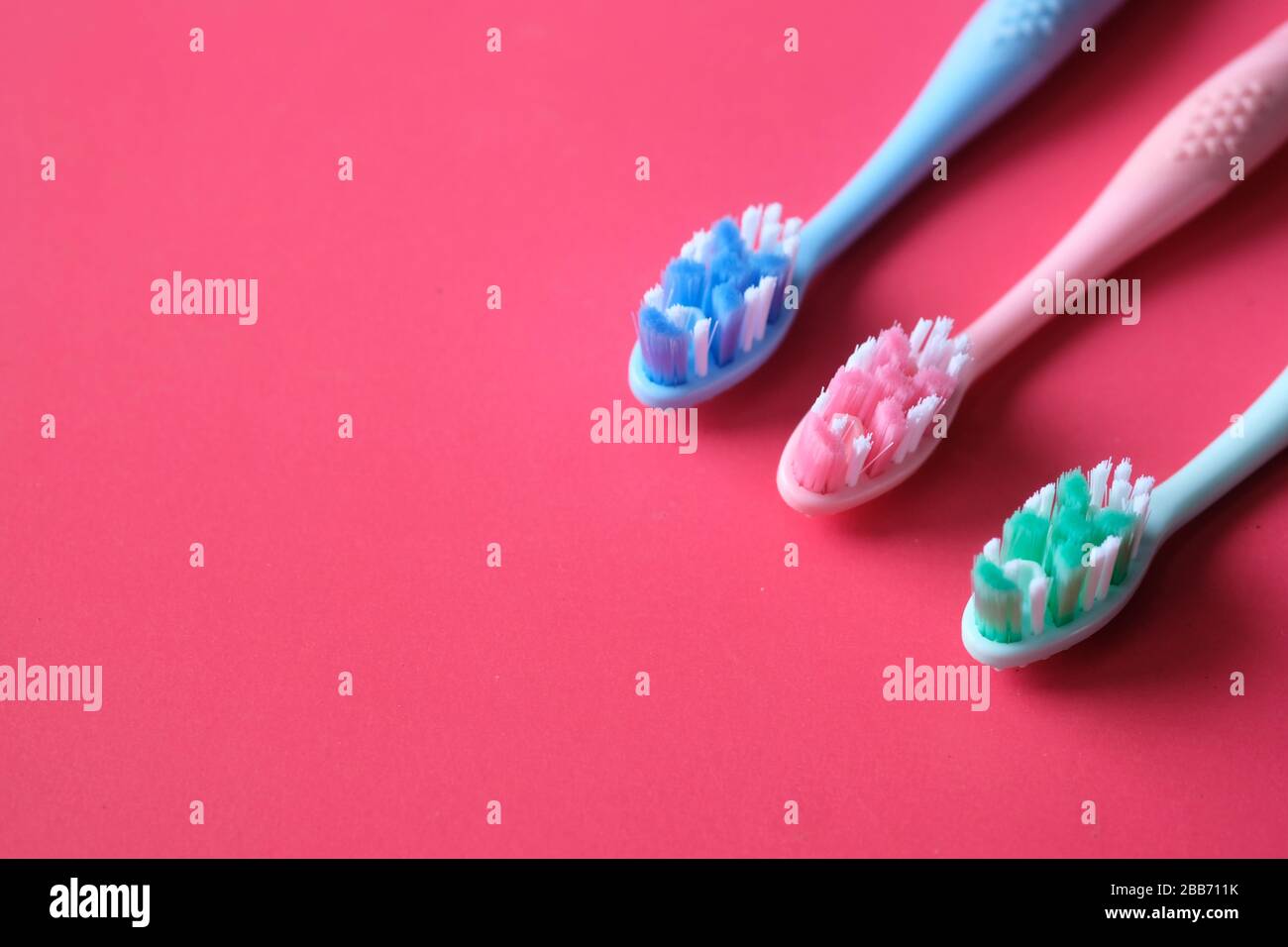 pink color toothbrush on red background, top view Stock Photo - Alamy