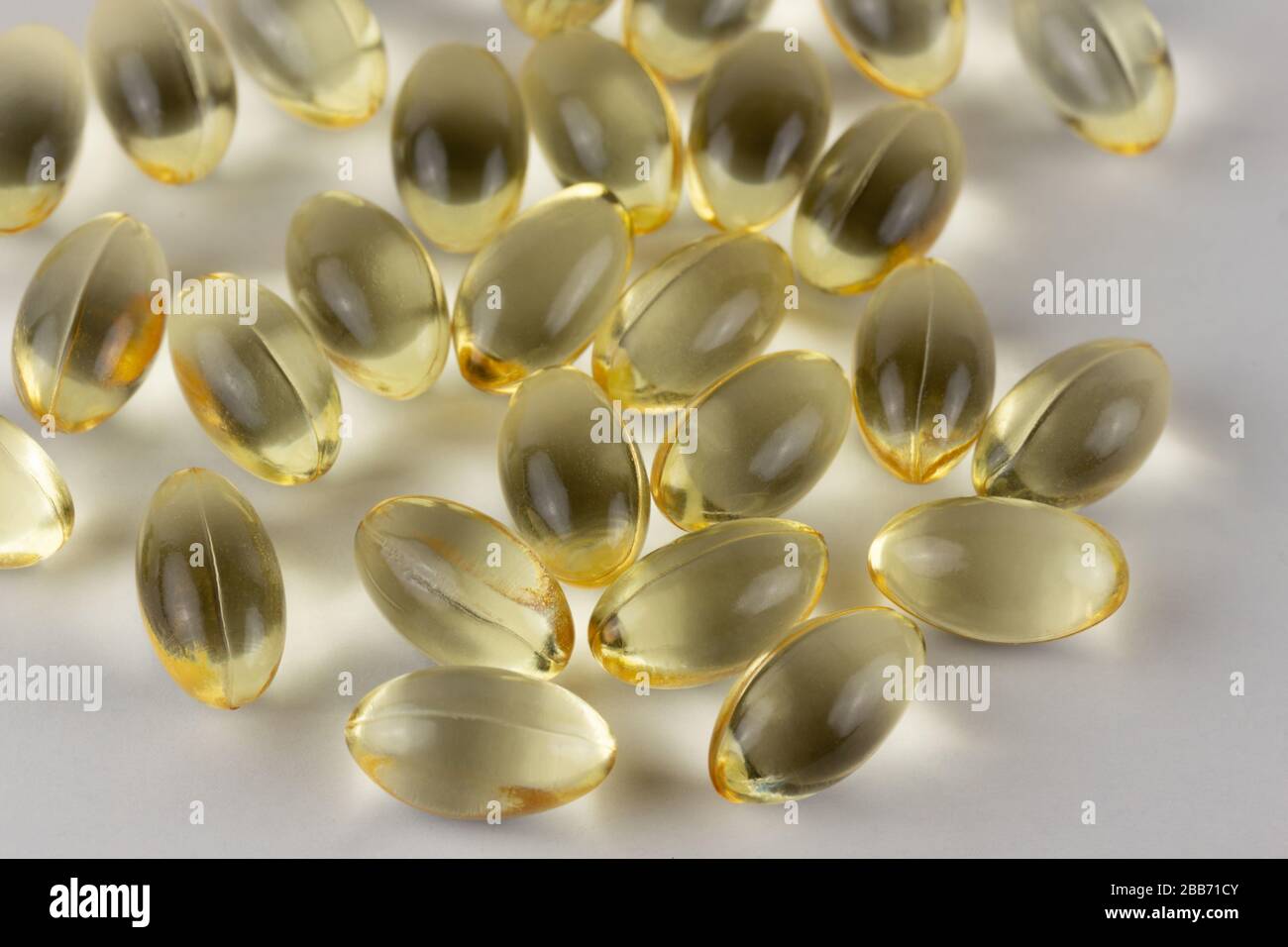 grouping of multiple gel tabs of fish oil, vitamin D or E supplements ...