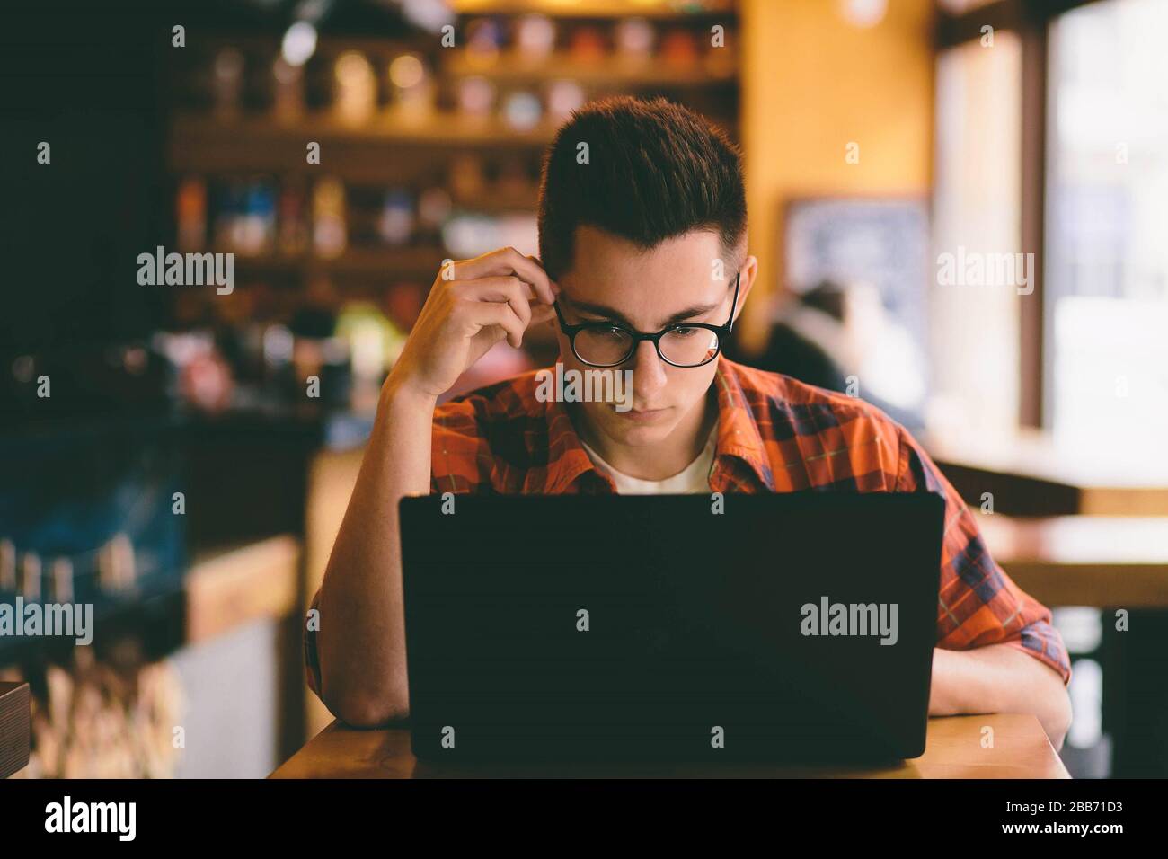 Happy casual man using laptop computer in cafe Stock Photo - Alamy