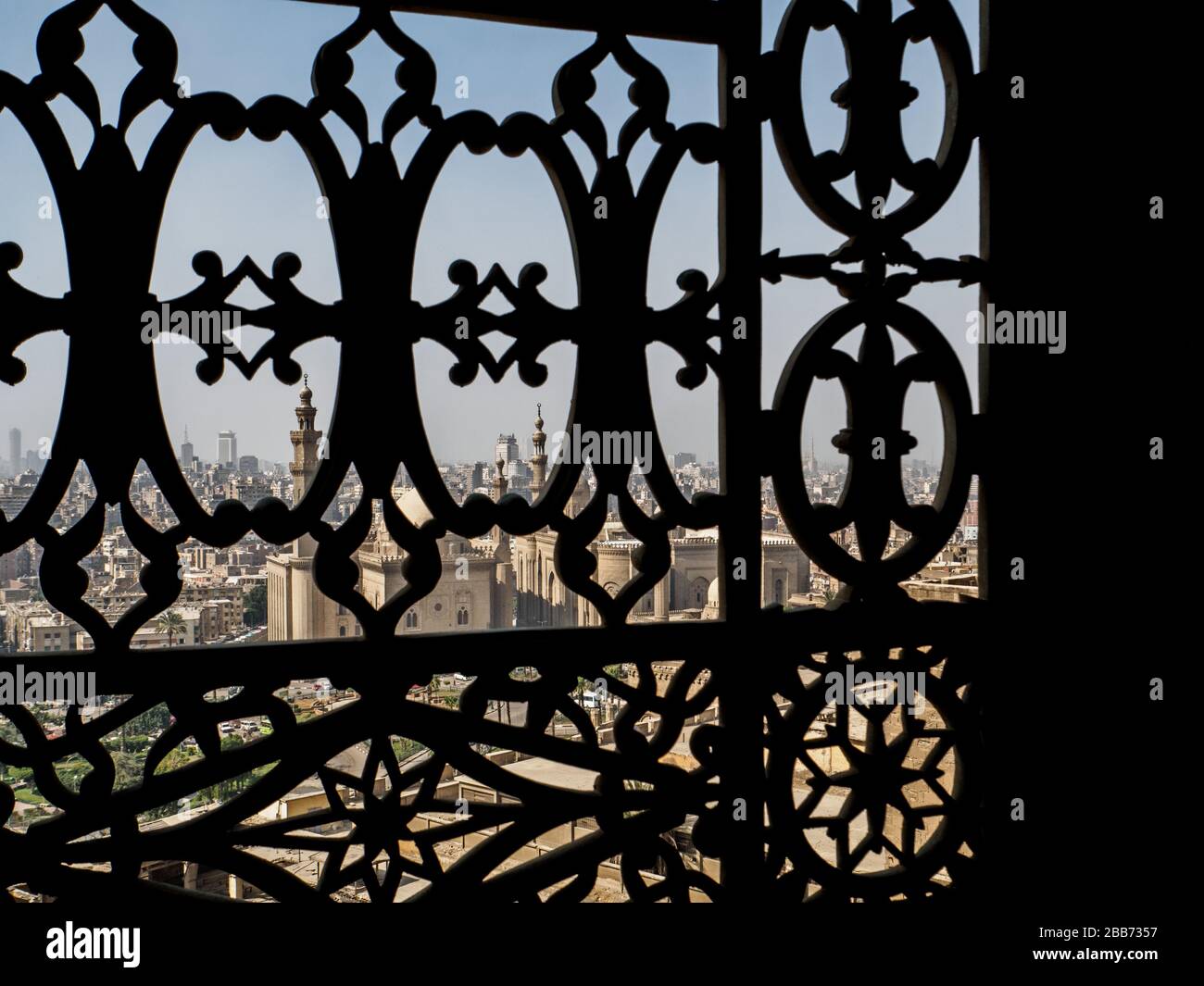 a look through a beatiful typical decorated window of a mosque onto ...