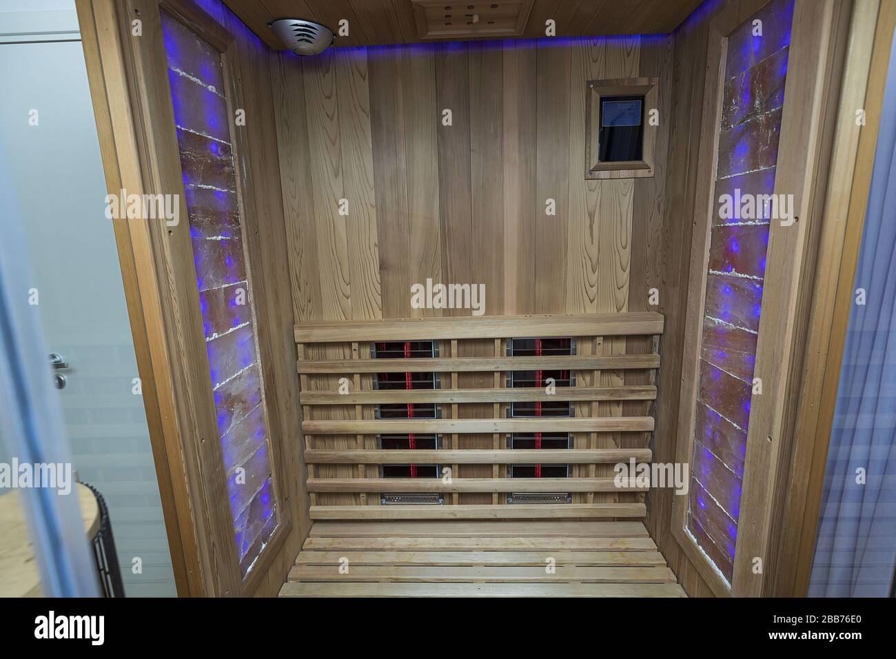 Infrared sauna interior close up view. Wooden walls and bench, ceramic ...