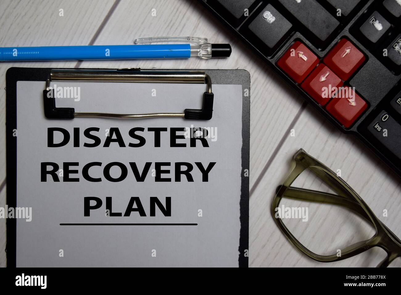 Disaster Recovery Plan write on a paperwork isolated on office desk ...