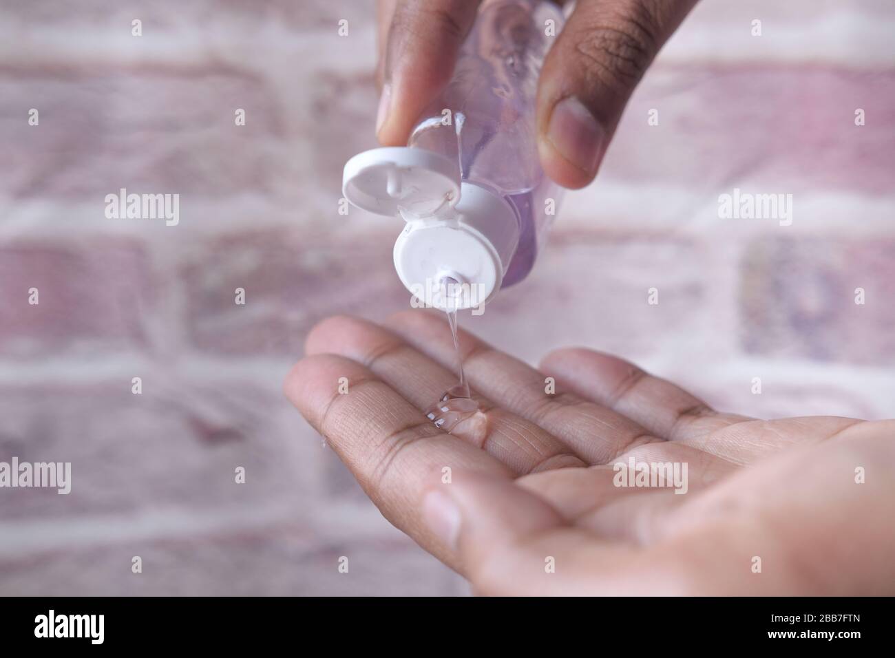 man hands using wash hand sanitizer gel dispenser Stock Photo - Alamy