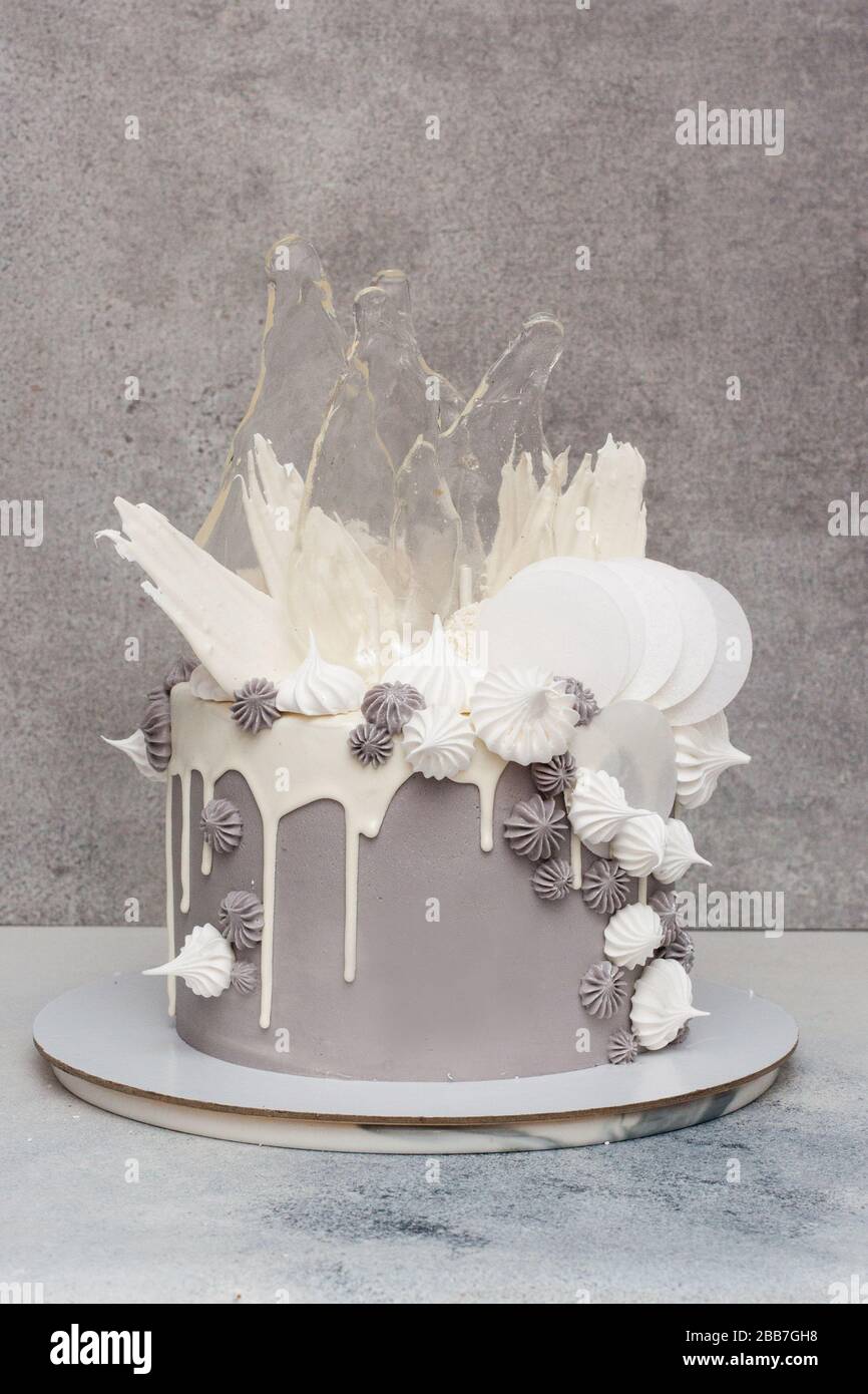 Elegant grey cake with modern design. Caramel, waffle paper, french ...