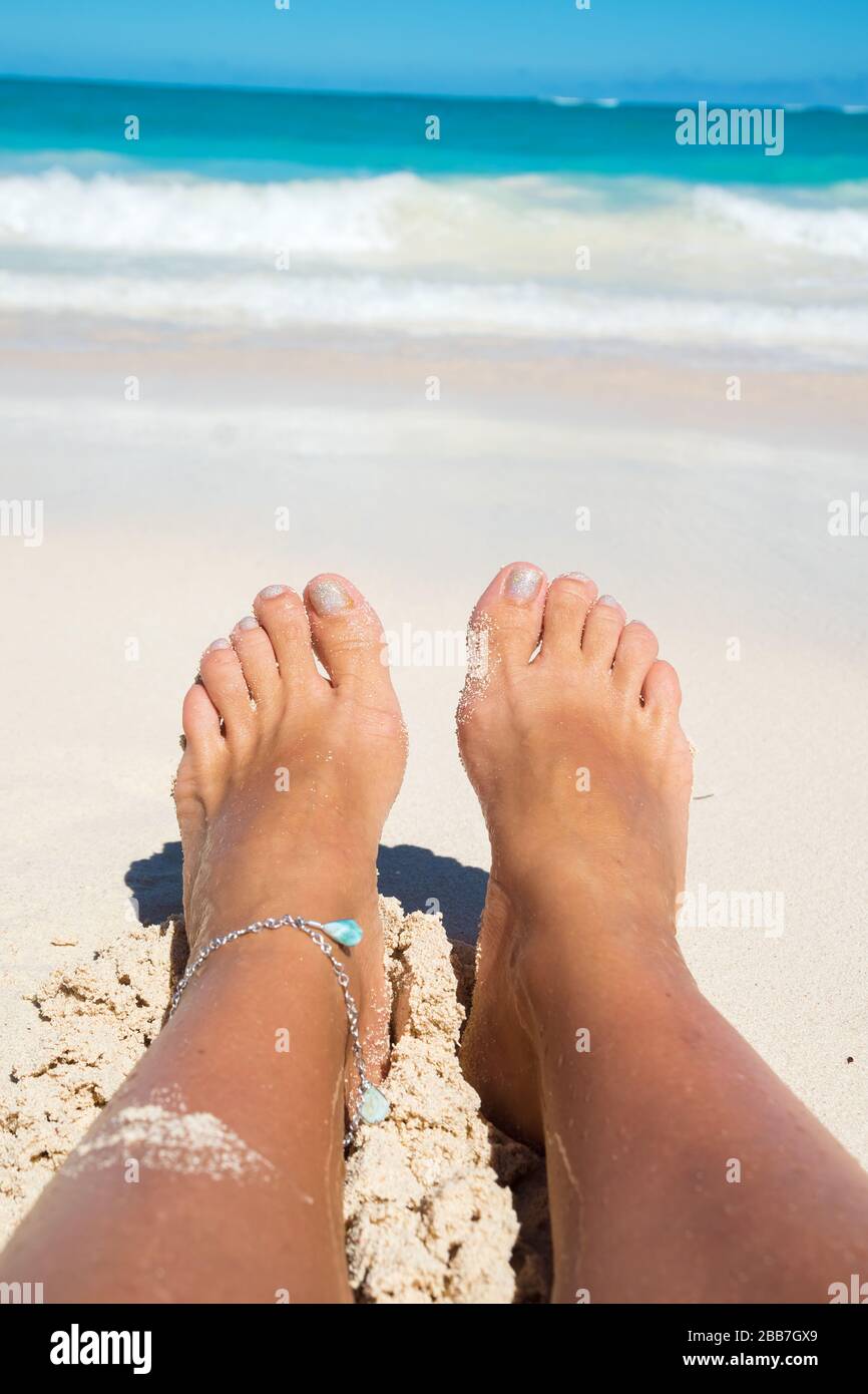 Beautiful tan legs photographed on the beach Stock Photo - Alamy