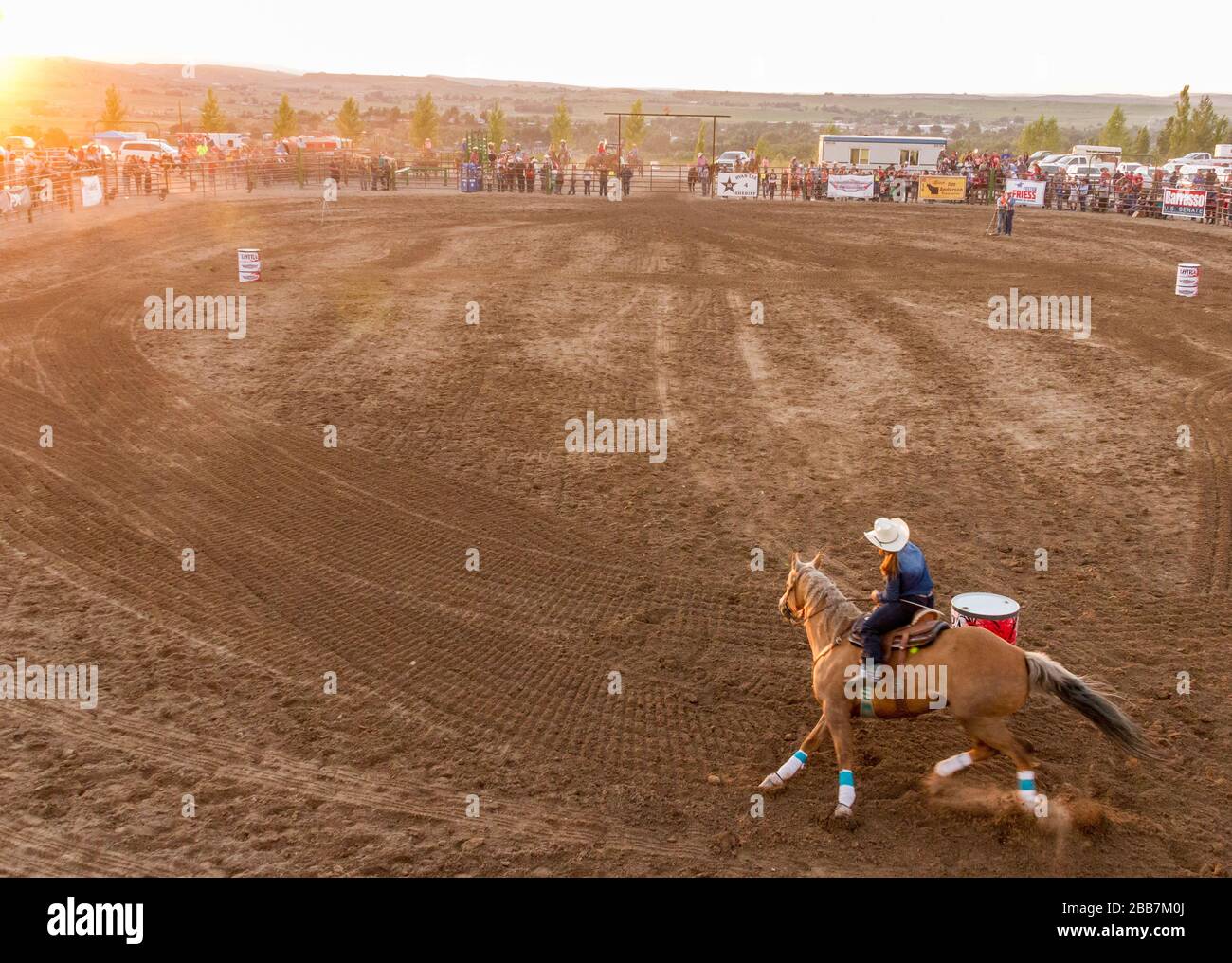 A barrel racer rounds the third barrel at the Pioneer Days Rodeo Stock ...