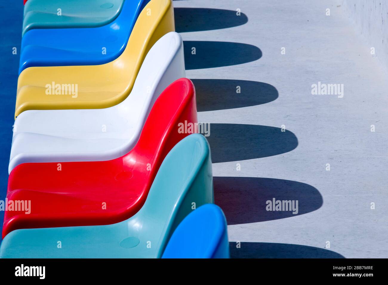 Colorful seats on the tier of the outdoor stadium Stock Photo - Alamy